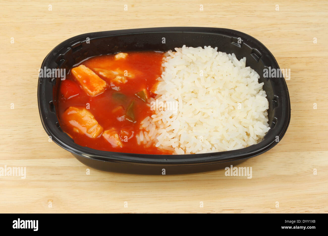 Convenience meal of Chinese sweet and sour chicken in a plastic carton ...