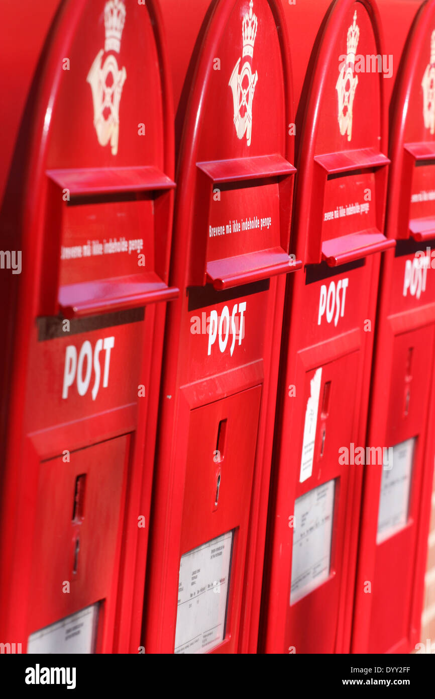 3 red post boxes and and white wall in denmark Stock Photo - Alamy