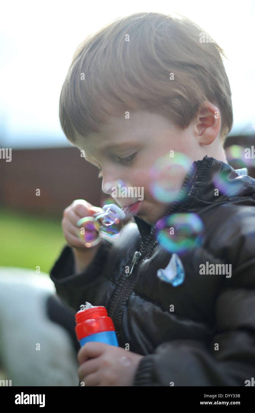 3 year old boy blowing bubbles Stock Photo - Alamy