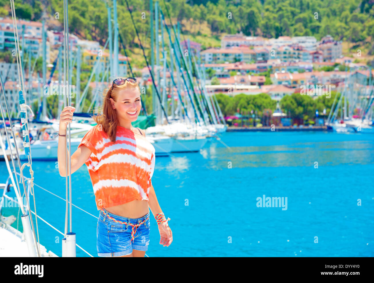 Cute girl having fun in yacht harbor, enjoying sunny summer day, active ...