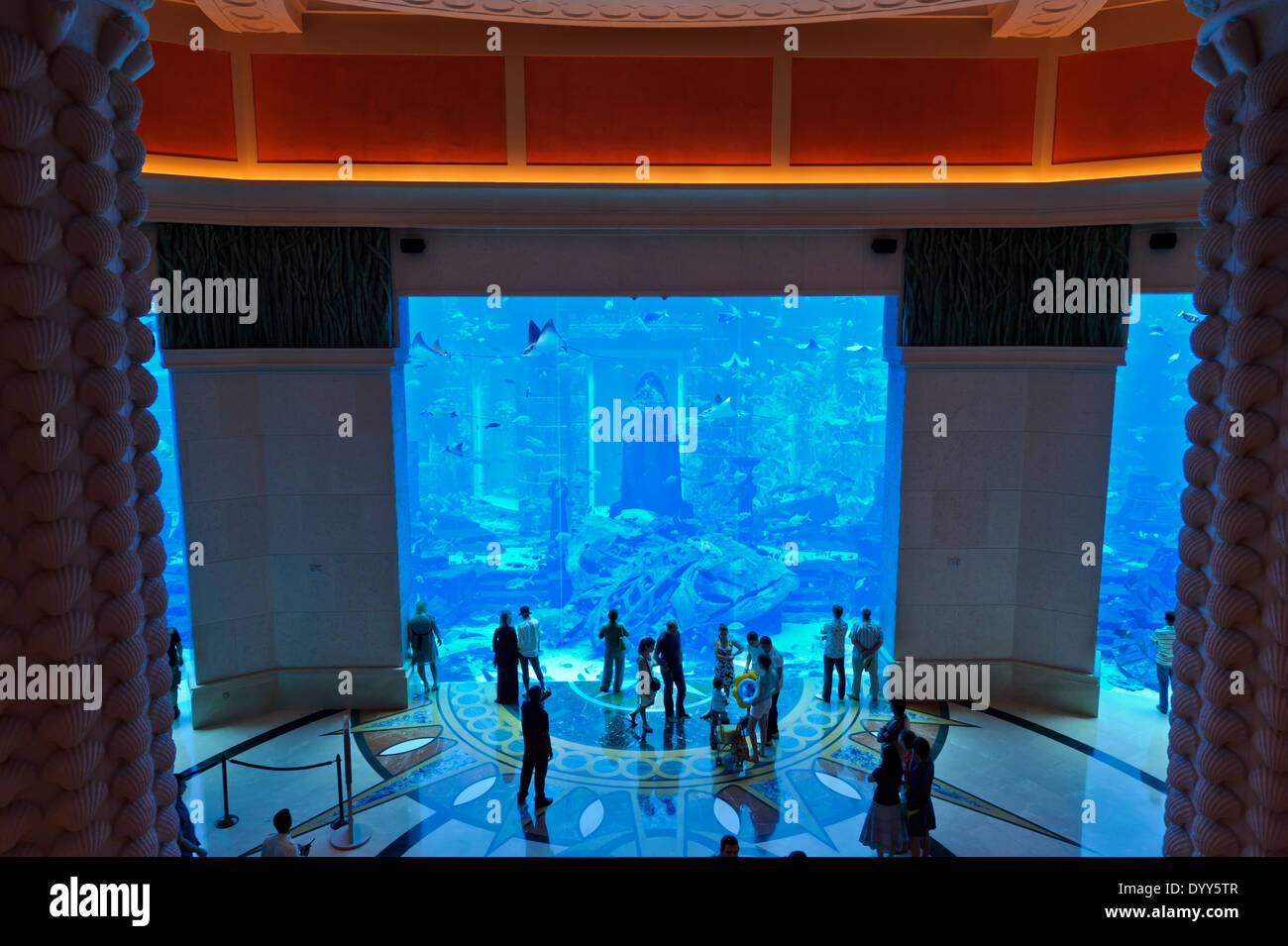 Visitors admiring exotic fish in a gigantic aquarium at the famous ...
