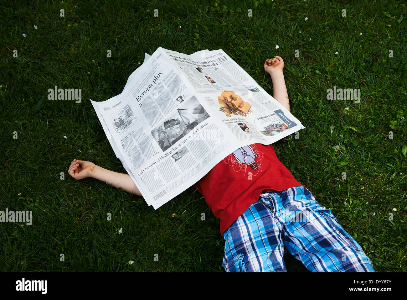 Boy reading newspaper hi-res stock photography and images - Alamy