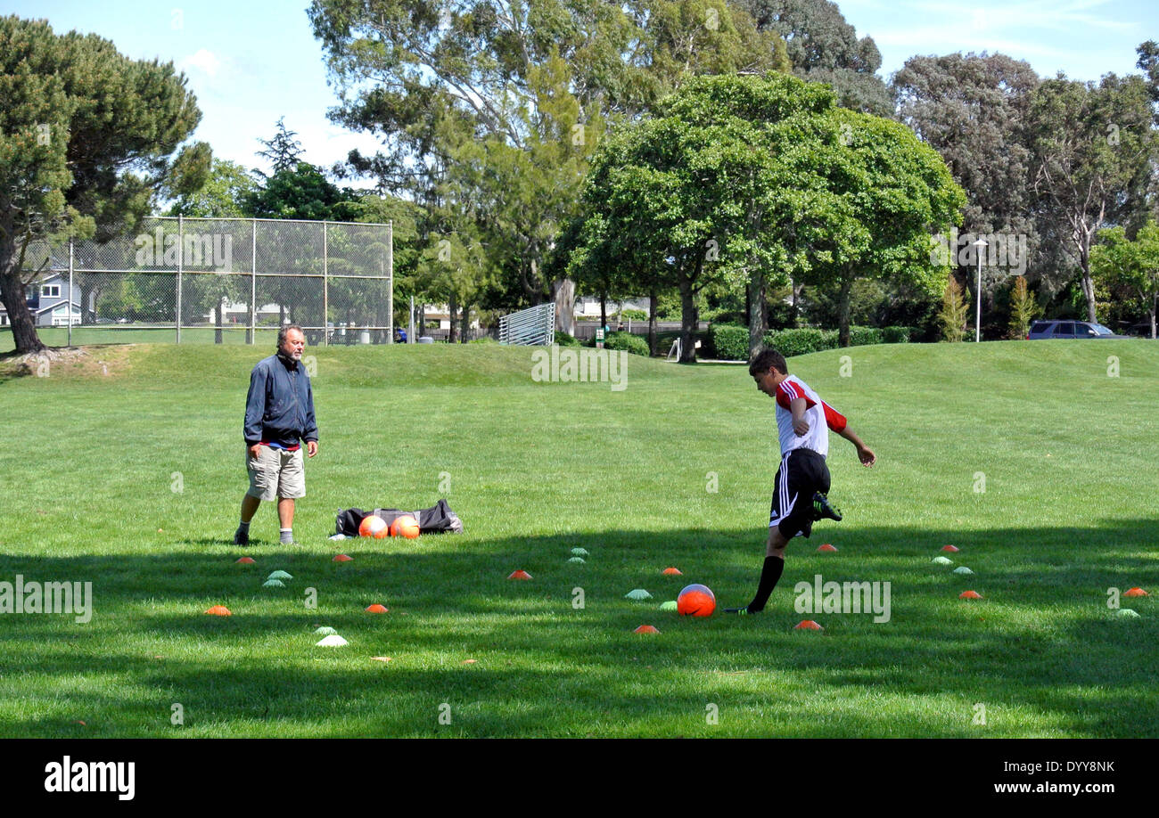 soccer coach watches student dribble and shoot goals Stock Photo - Alamy