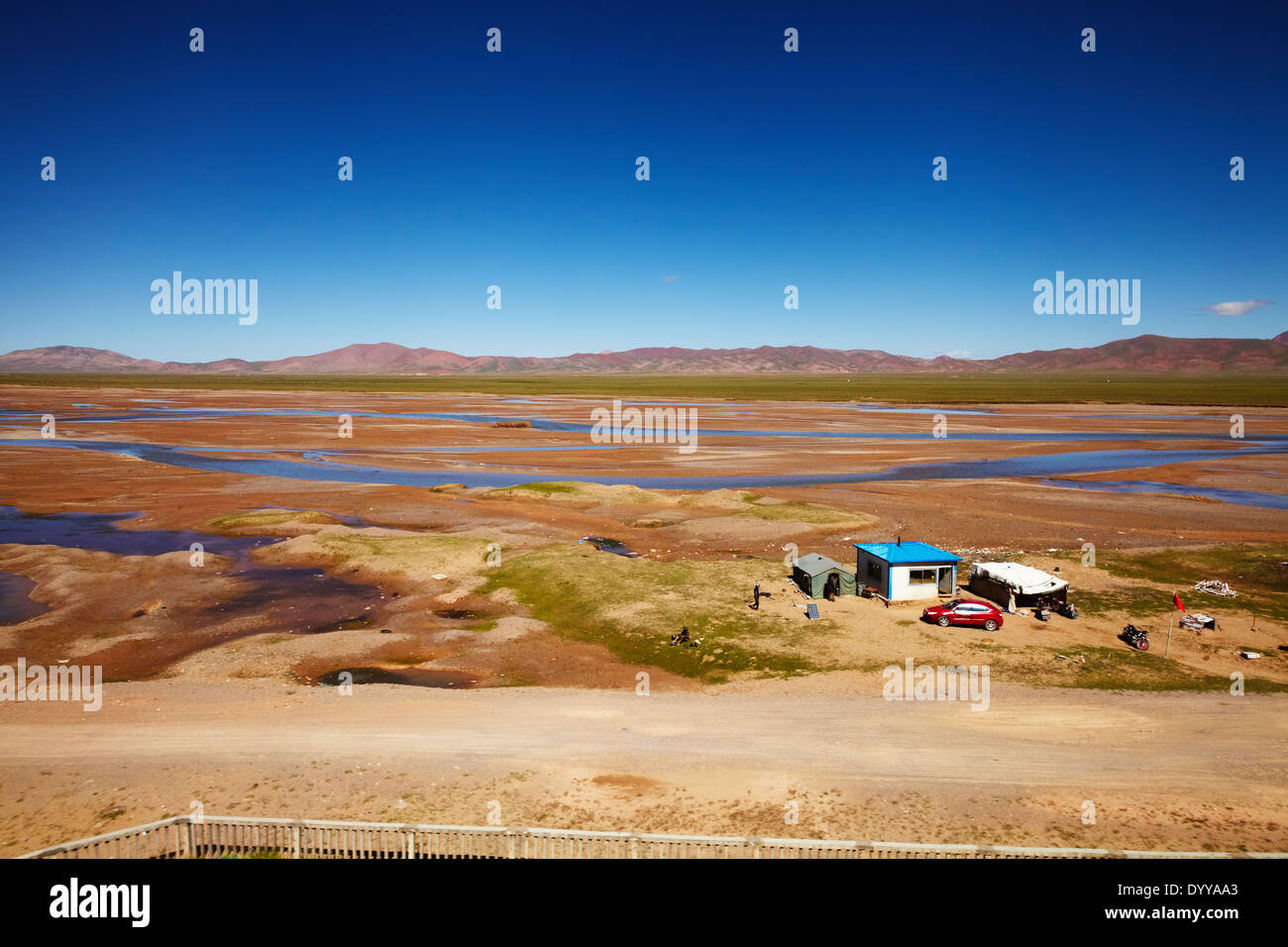 A small outpost at the Tibetan Plateau with mountain landscape in the ...