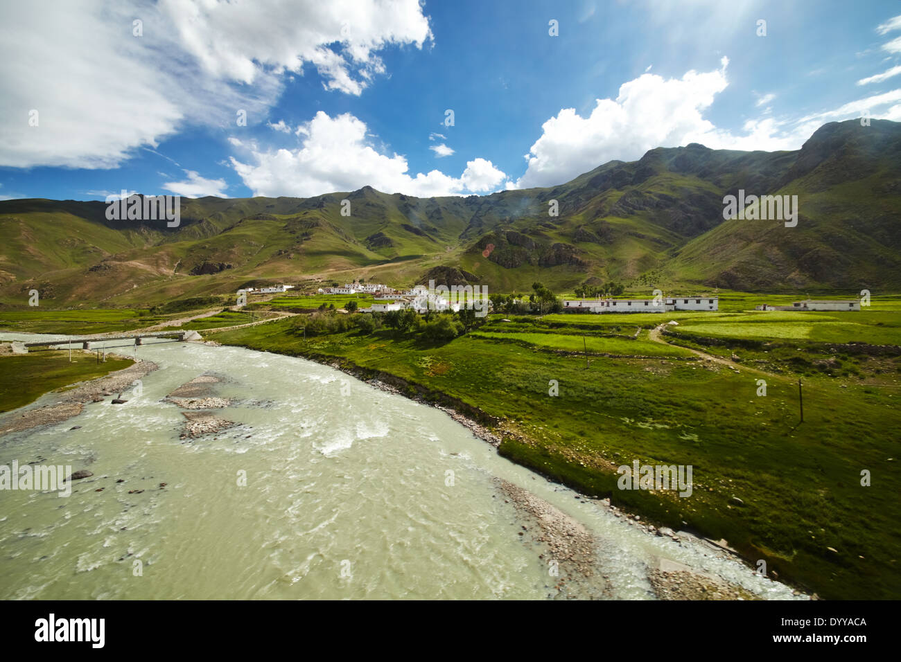 A rural Tibetan settlement by the river. Mountain landscape on the ...