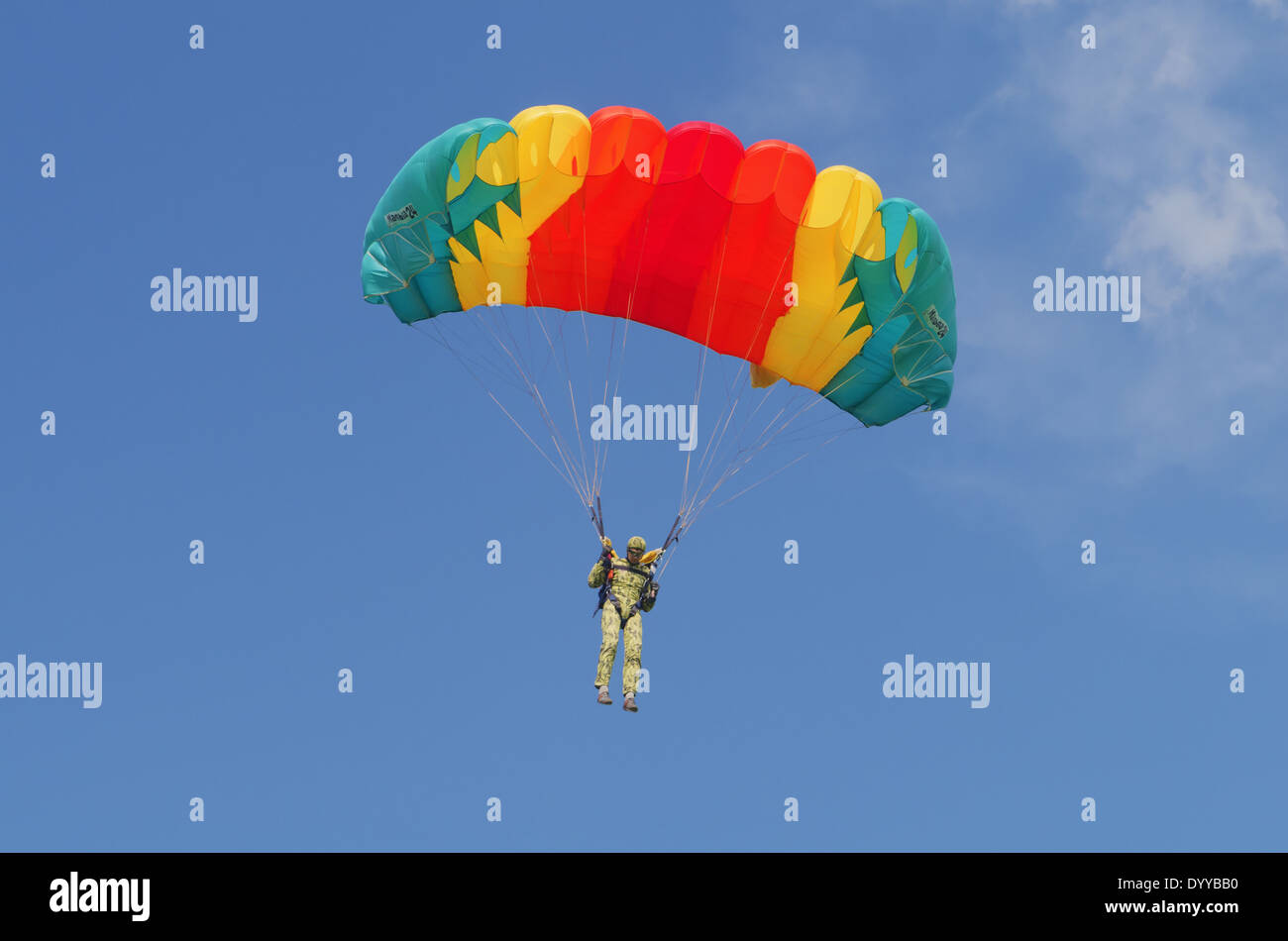 One day with parachutist in airfield. The skydiver lands under the red ...