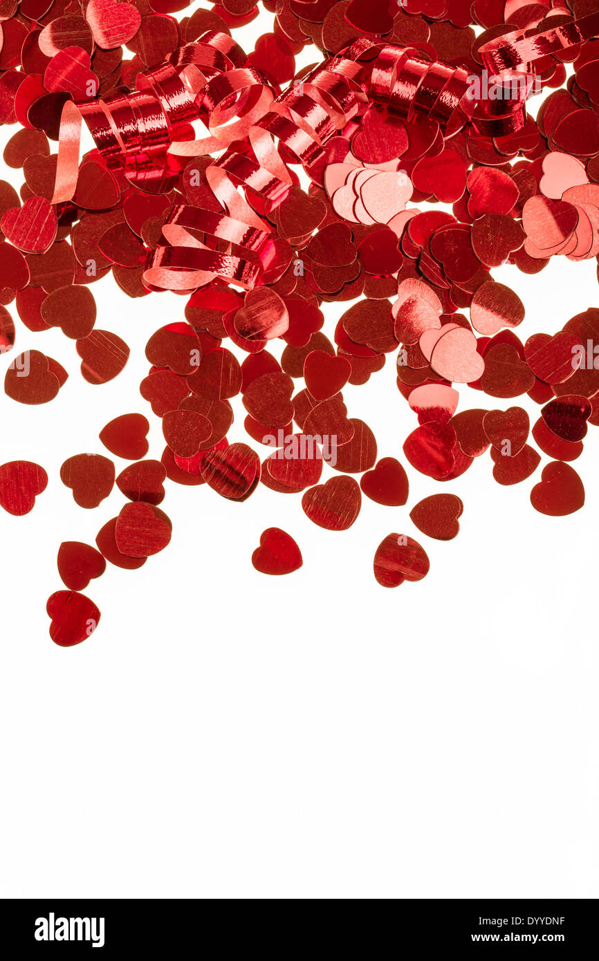 small red hearts confetti isolated on white background Stock Photo - Alamy