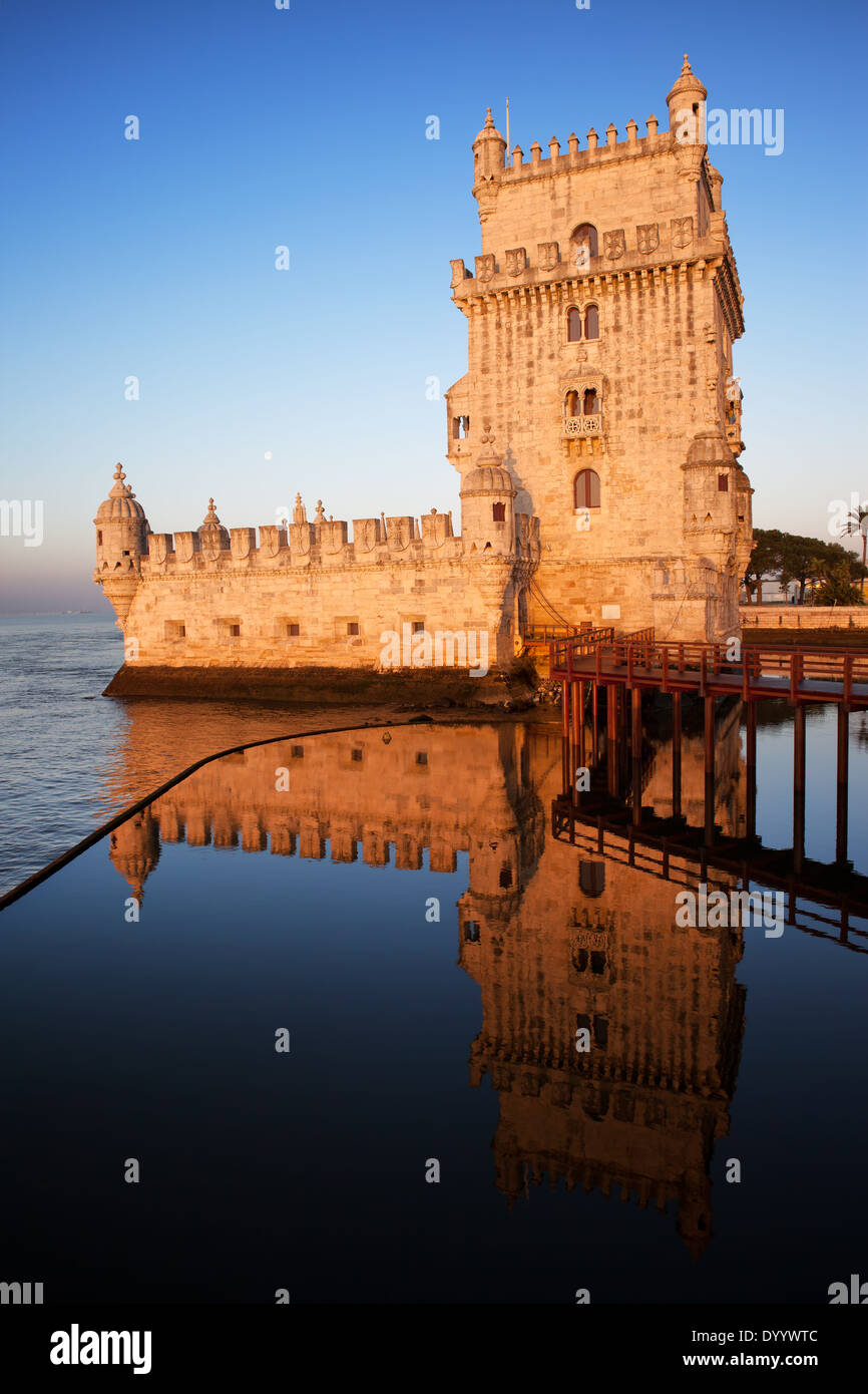 Belem Tower on the Tagus river at sunrise with reflection on water in ...