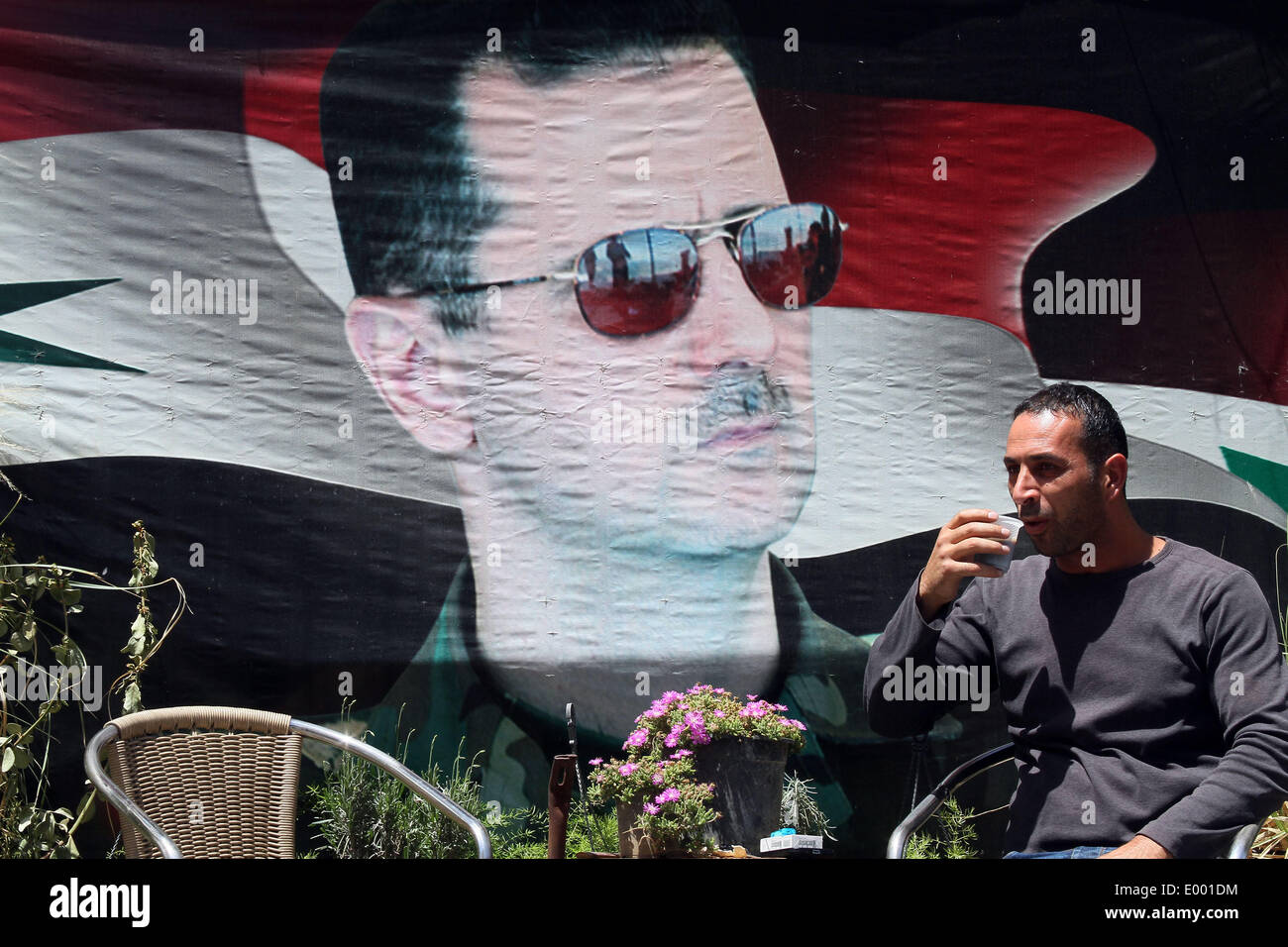 Damascus, Syria. 28th Apr, 2014. A Syrian man takes a drink beside a ...