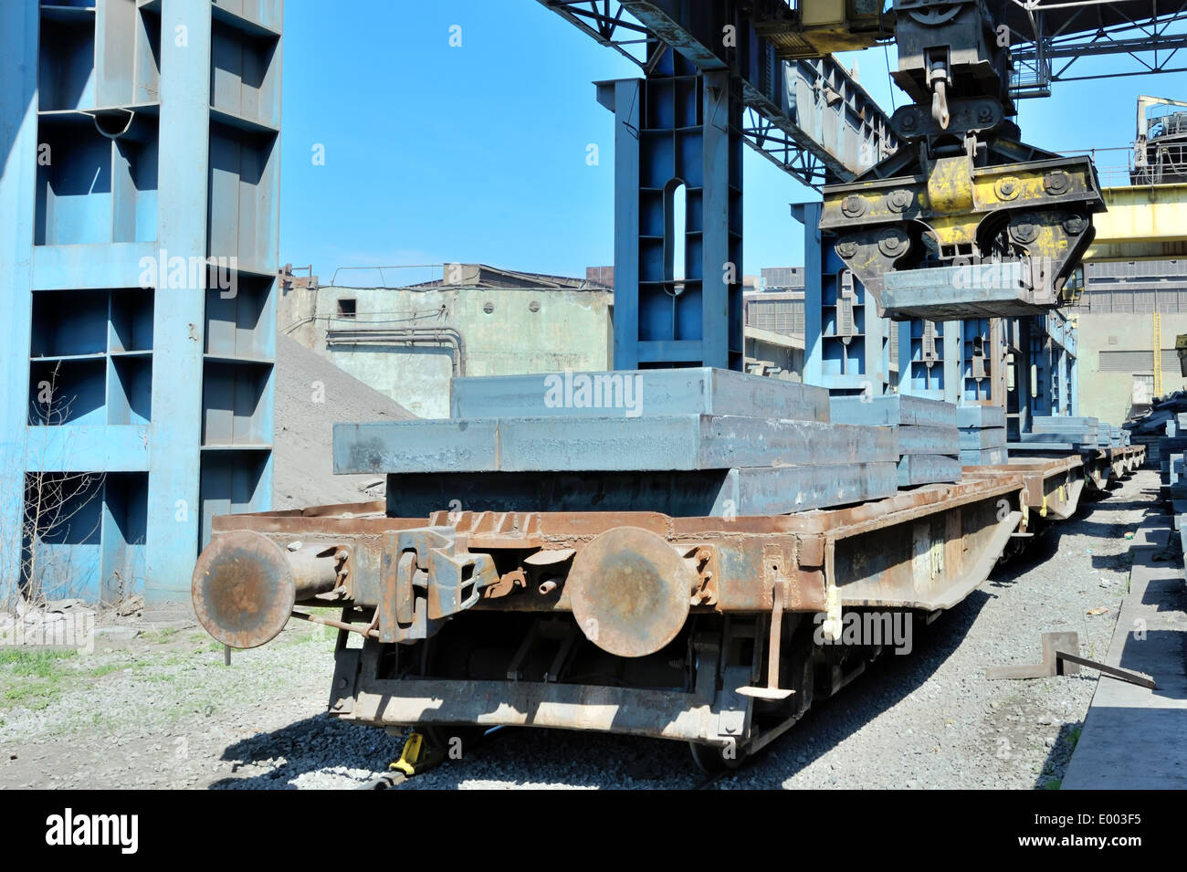Huge cranes loading steel stack at the plant Stock Photo - Alamy