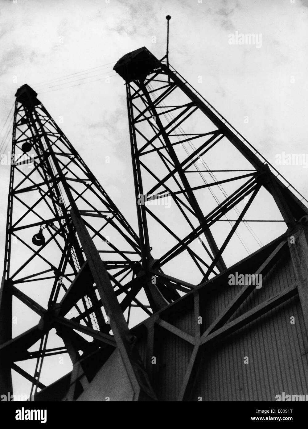 Two construction cranes in Black and White Stock Photos & Images - Alamy