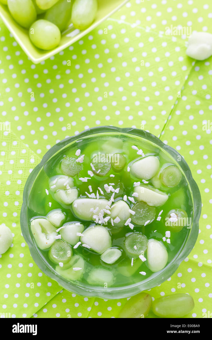 Delicious fruit jelly with grapes dusted with coconut shreds Stock ...