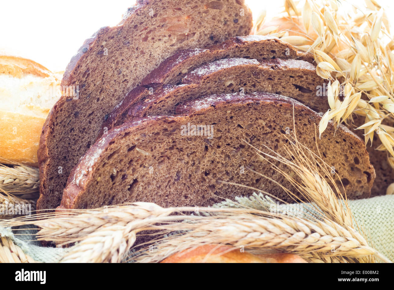 Loaf of bread sliced with crispy rolls Stock Photo - Alamy