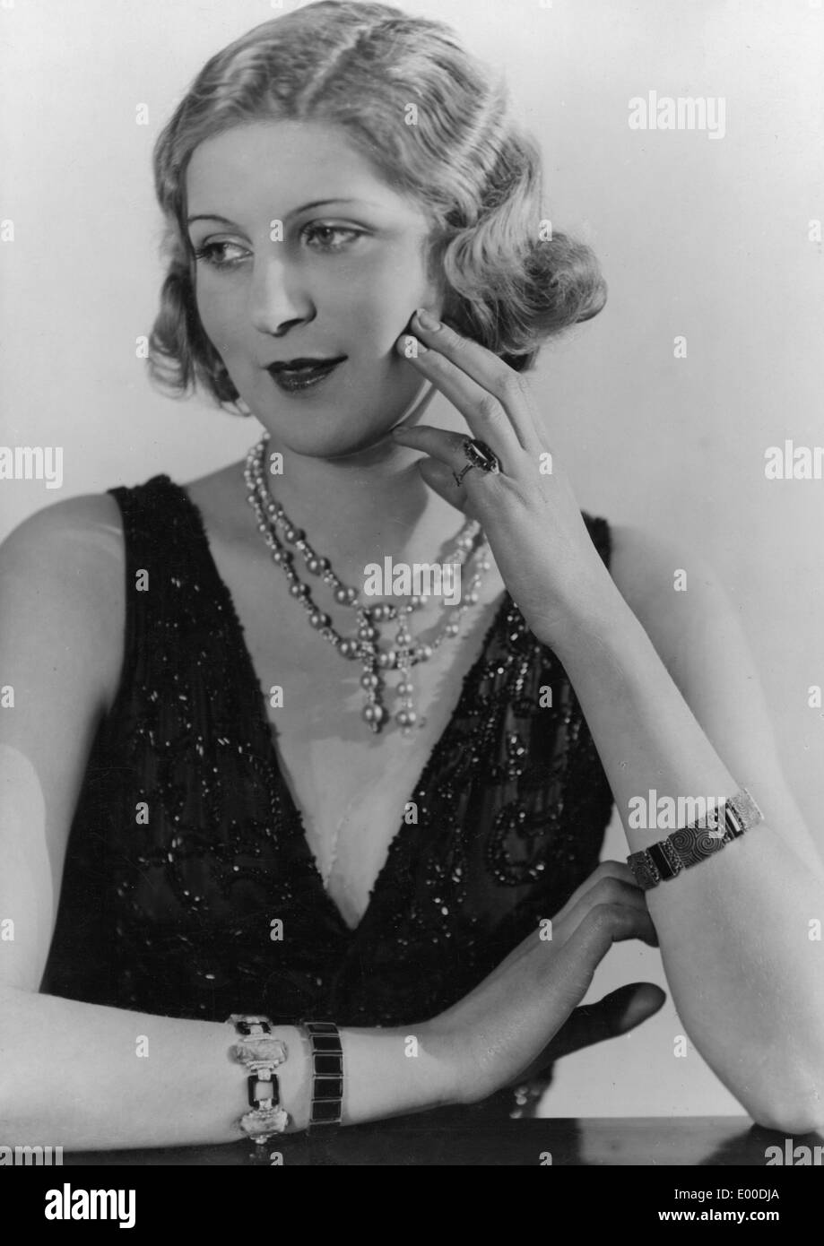 A woman wearing a dress and a pearl necklace hi-res stock photography ...