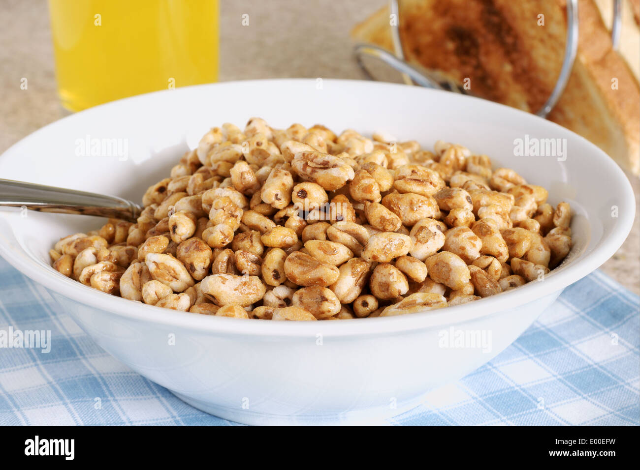 Honey coated puffed wheat breakfast cereal Stock Photo - Alamy