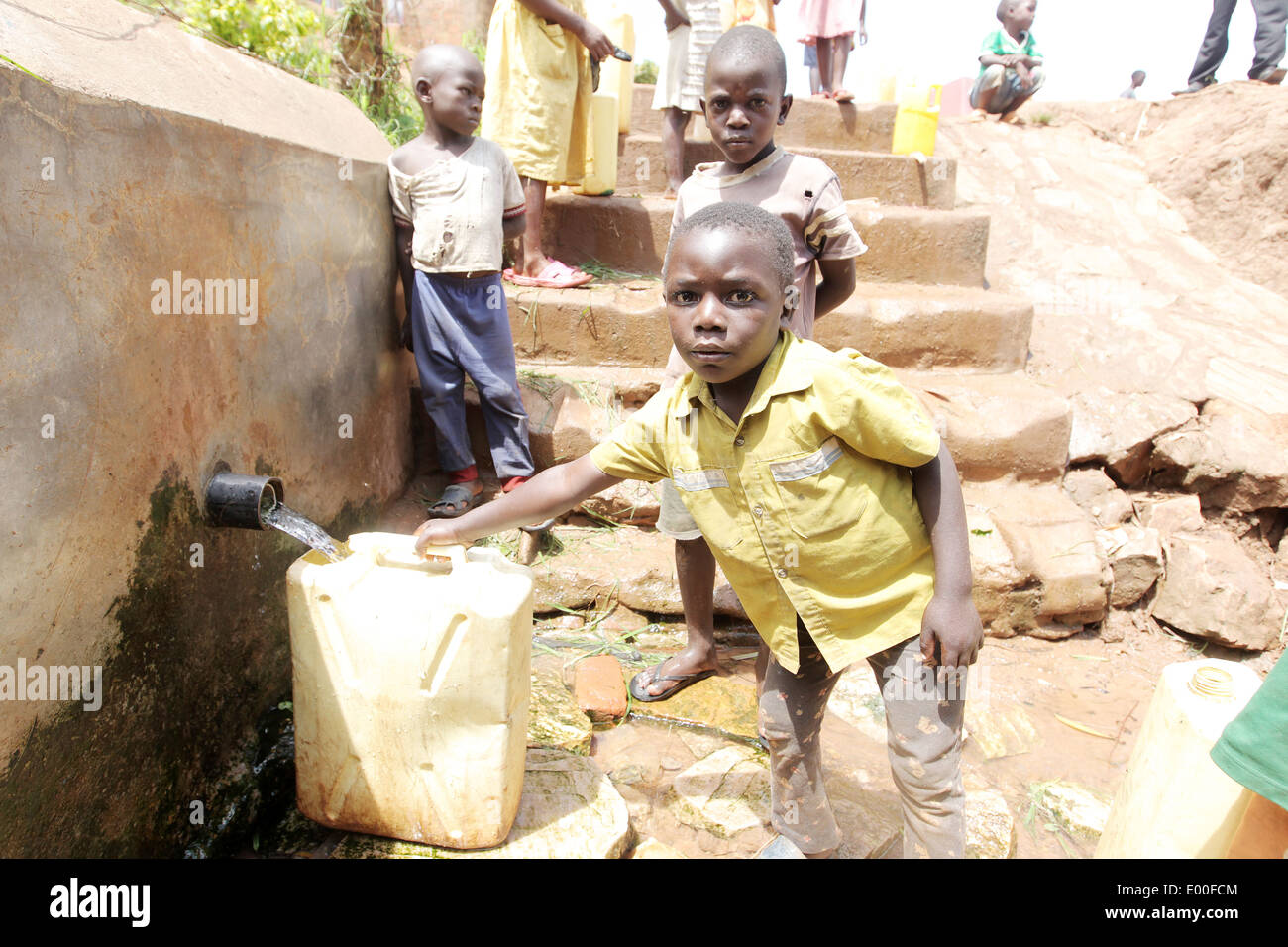Children collect water from an unclean government water source in the ...