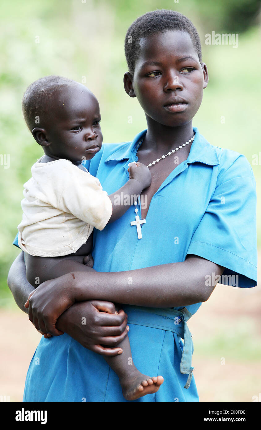 A village girl and child in a rural area of the Lira district in ...