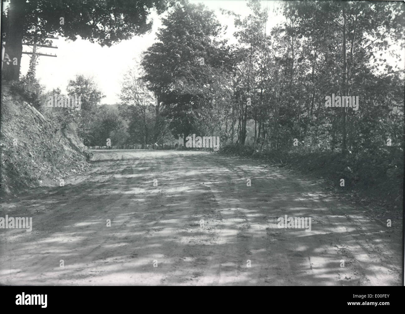 This photograph depicts a rural road with a stone wall in *Keene, New ...