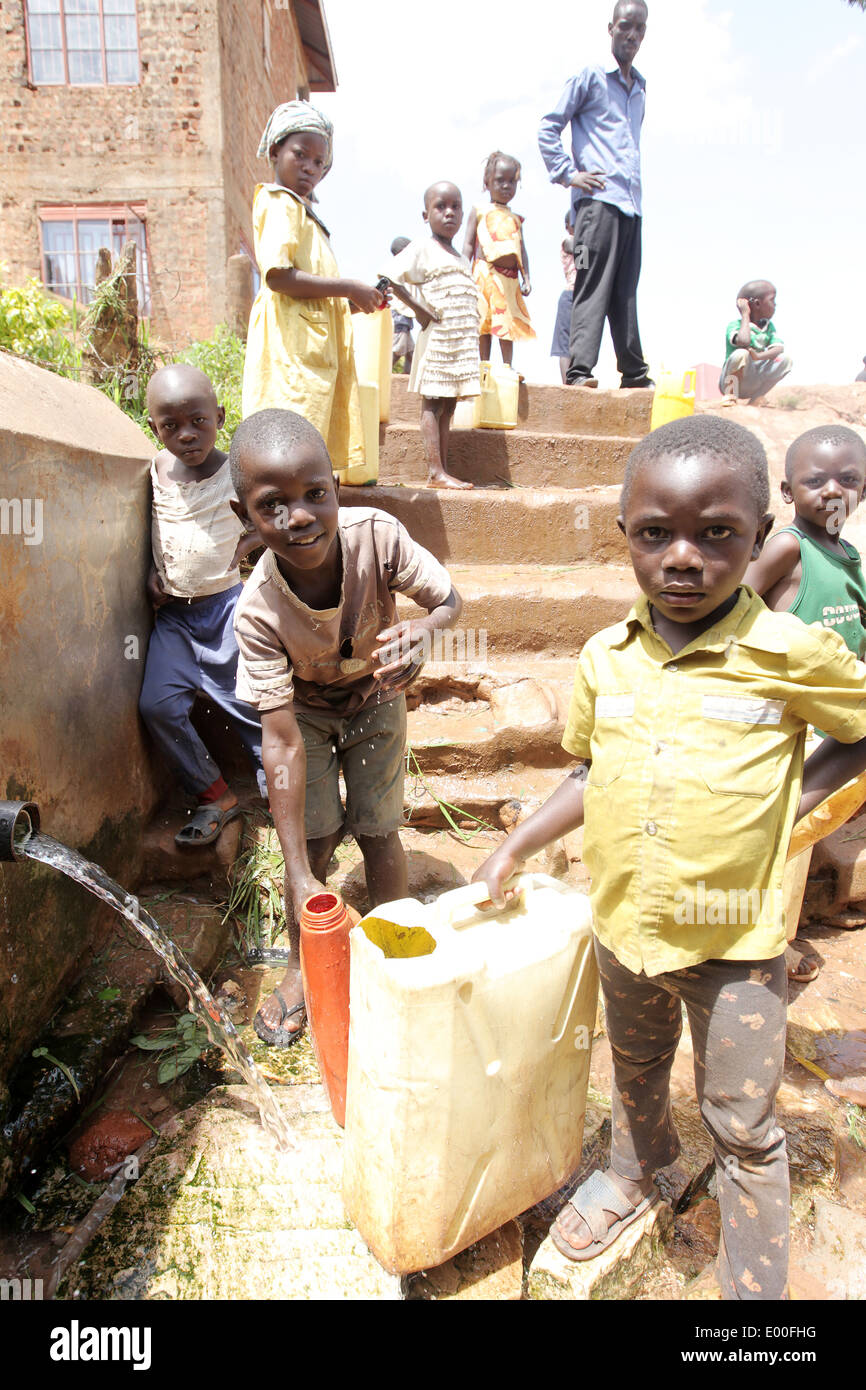 Children collect water from an unclean government water source in the ...