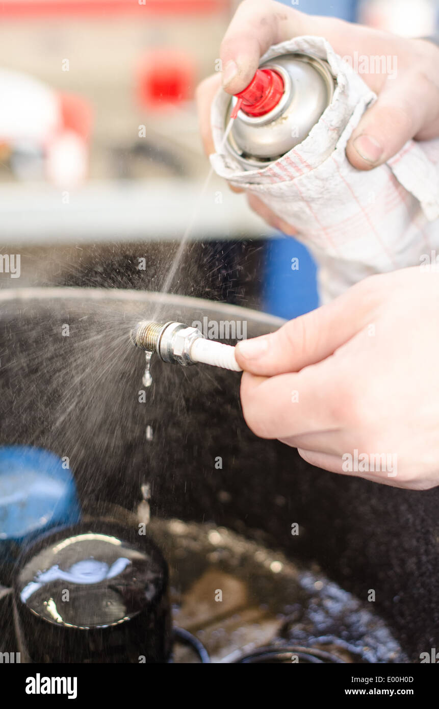 Spark plug cleaning in repair shop Stock Photo - Alamy