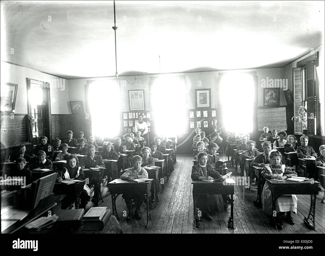This historical photograph captures children in a classroom in Keene ...