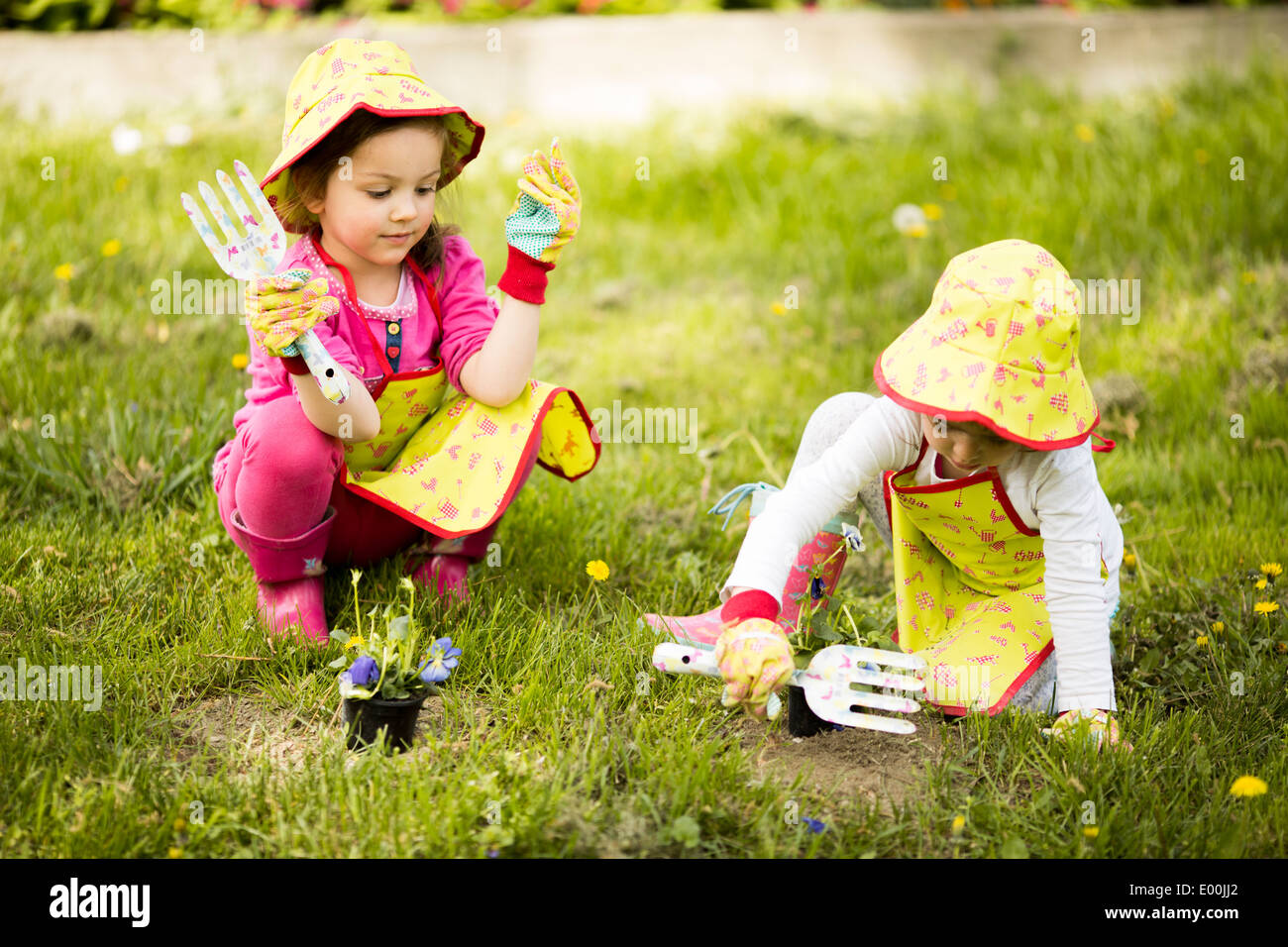 Little girls in the garden Stock Photo - Alamy