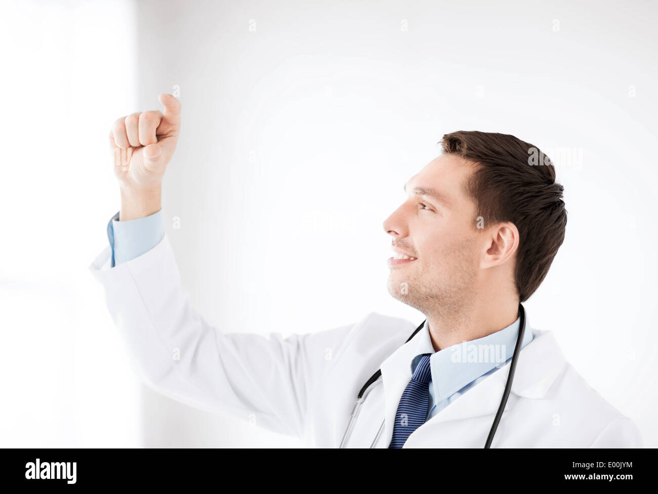 young doctor holding something imaginary Stock Photo - Alamy