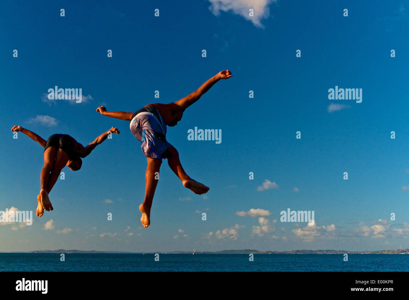 Two boys jump into the waters of the Bay of All Saints. Salvador, Bahia ...