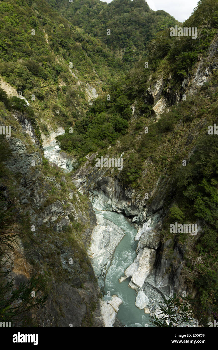 Landscape of lush and steep mountains, deep ravine and a river at the ...