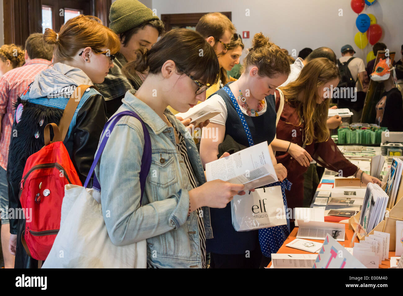 Visitors browse the exhibitors' booths at the Brooklyn Zine Fest in New ...