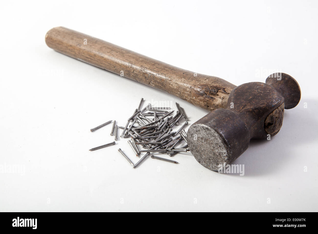An old engineers hammer on a white studio background with nails Stock ...