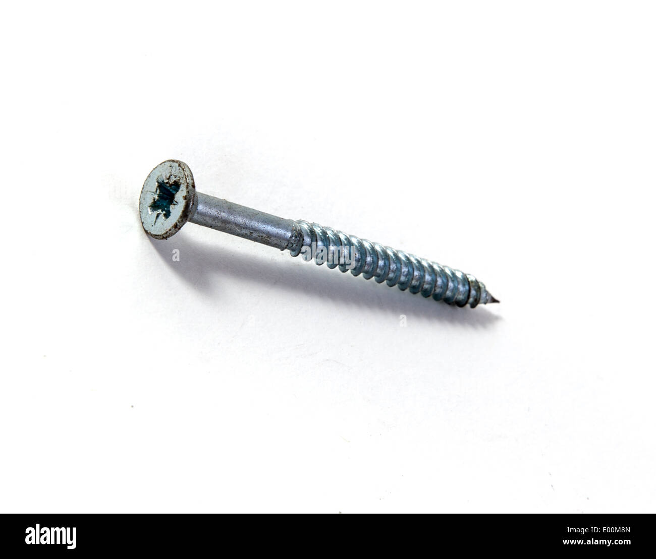 A close up of cross screws and nails on a white background Stock Photo ...