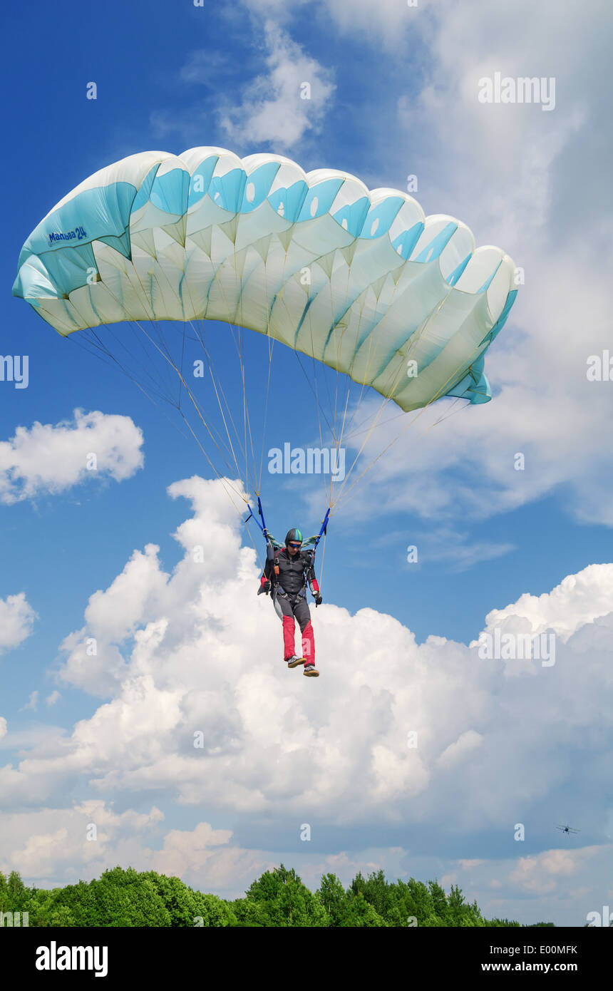 One day with parachutist in airfield. The skydiver lands under the ...