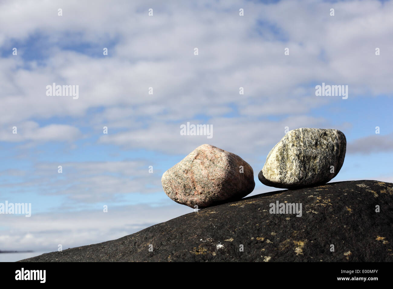 Two small rocks balanced on a large rock on the beach at Gairloch ...