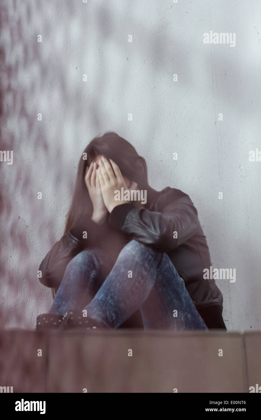 Sad teenage girl with hands over face Stock Photo - Alamy