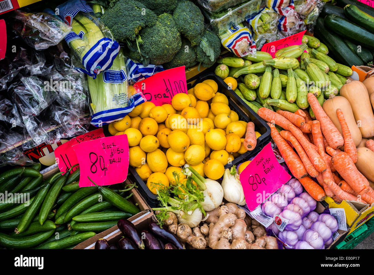 Market display of a variety of colourful fruit and vegetables in trays ...