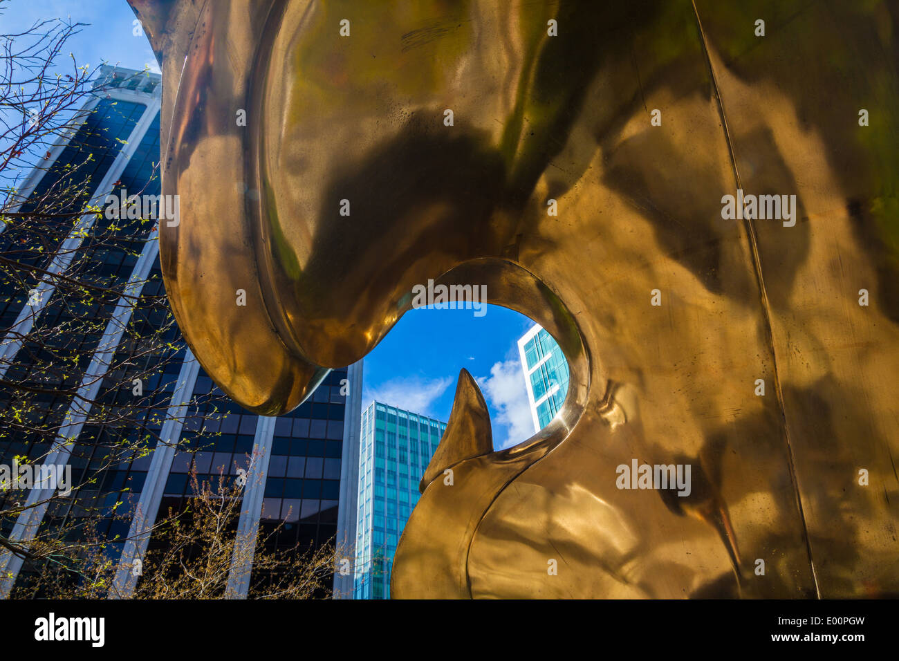 Towers of downtown Vancouver through an opening in a brass statue Stock ...