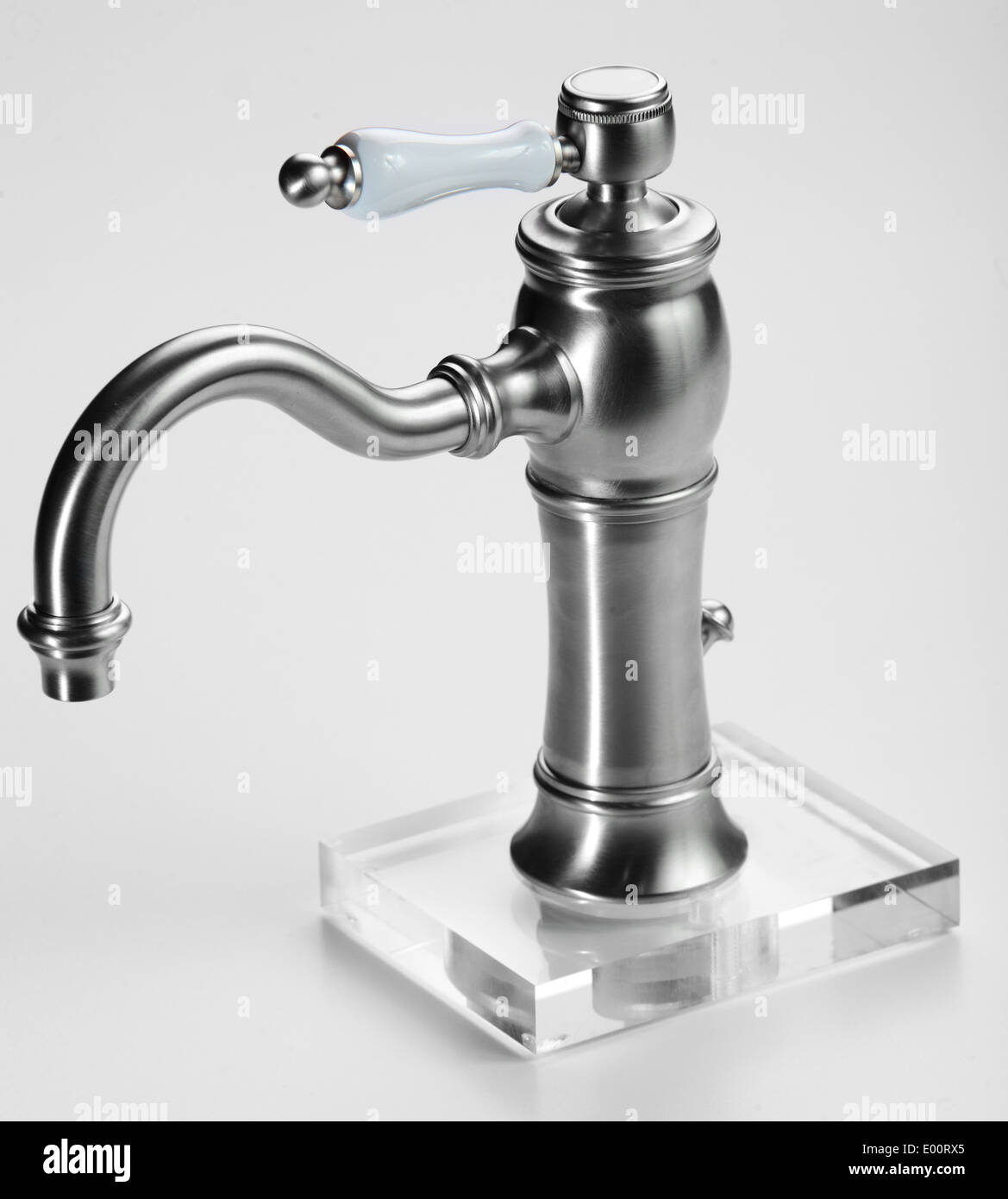 Brand new water tap on bright background Stock Photo - Alamy