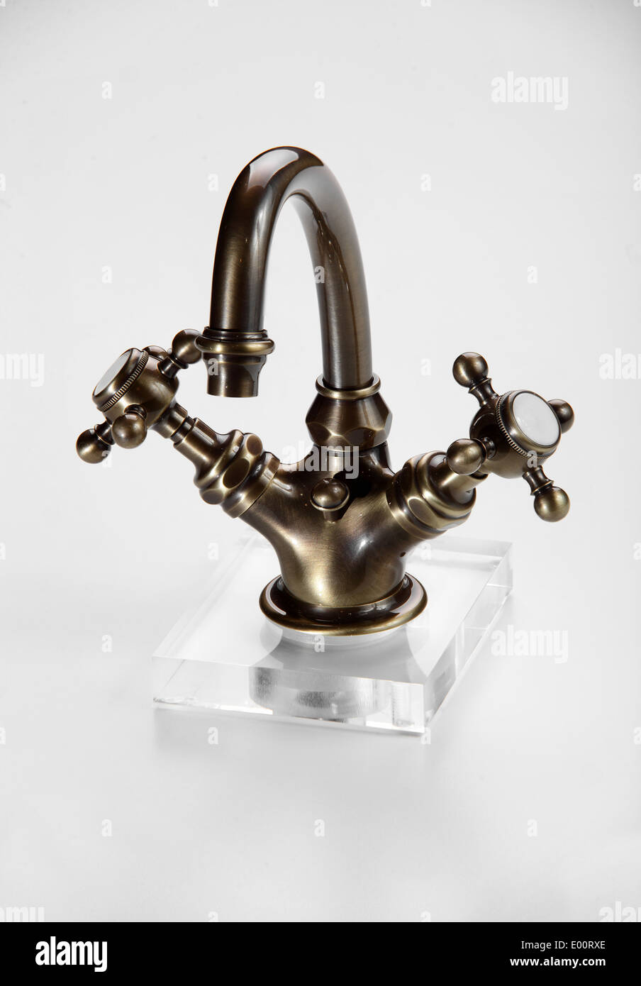 Brand new water tap on bright background Stock Photo - Alamy