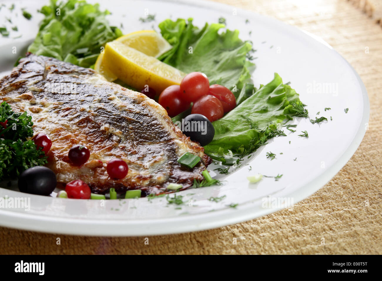 roasted and hot fish mith vegetables Stock Photo - Alamy