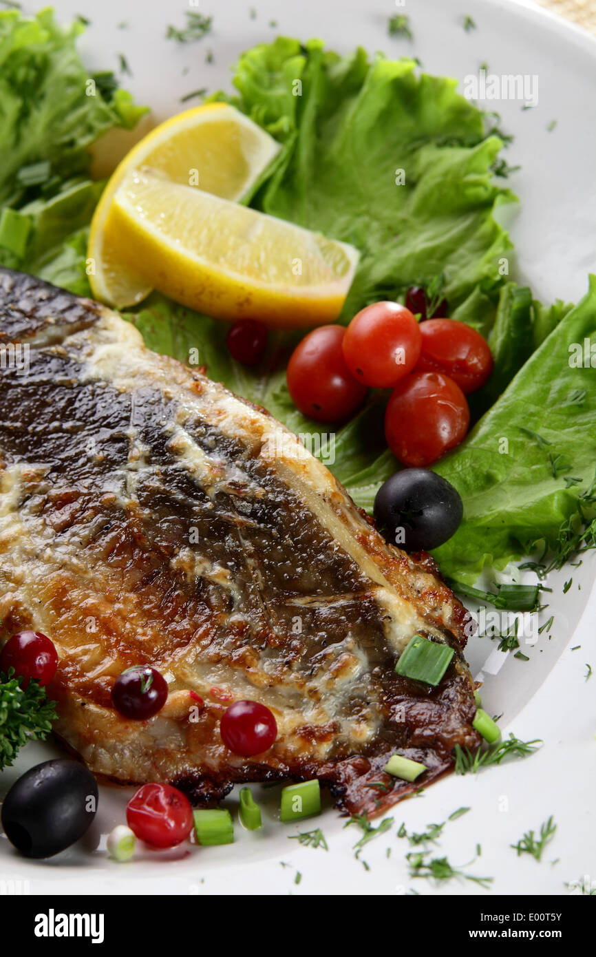 roasted and hot fish mith vegetables Stock Photo - Alamy