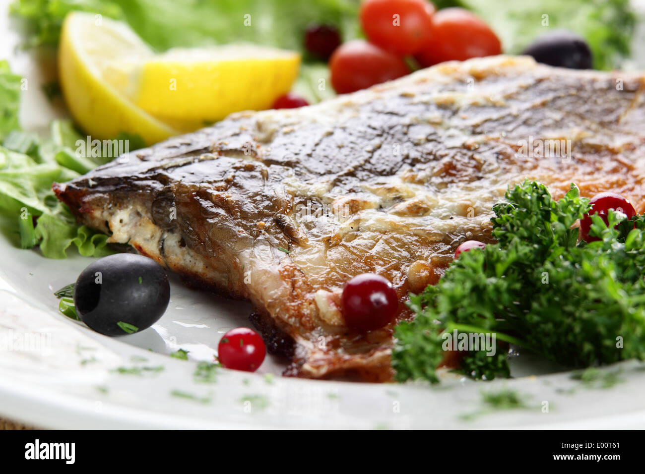 roasted and hot fish mith vegetables Stock Photo - Alamy