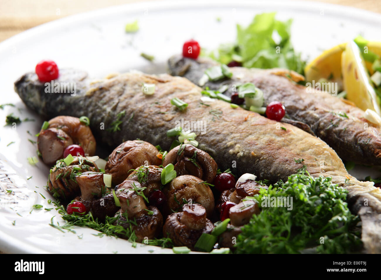 roasted and hot fish mith vegetables and mushrooms Stock Photo - Alamy
