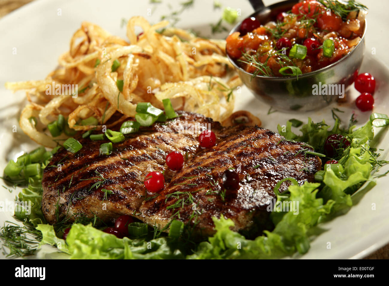 grilled meat in white dish with souce Stock Photo - Alamy