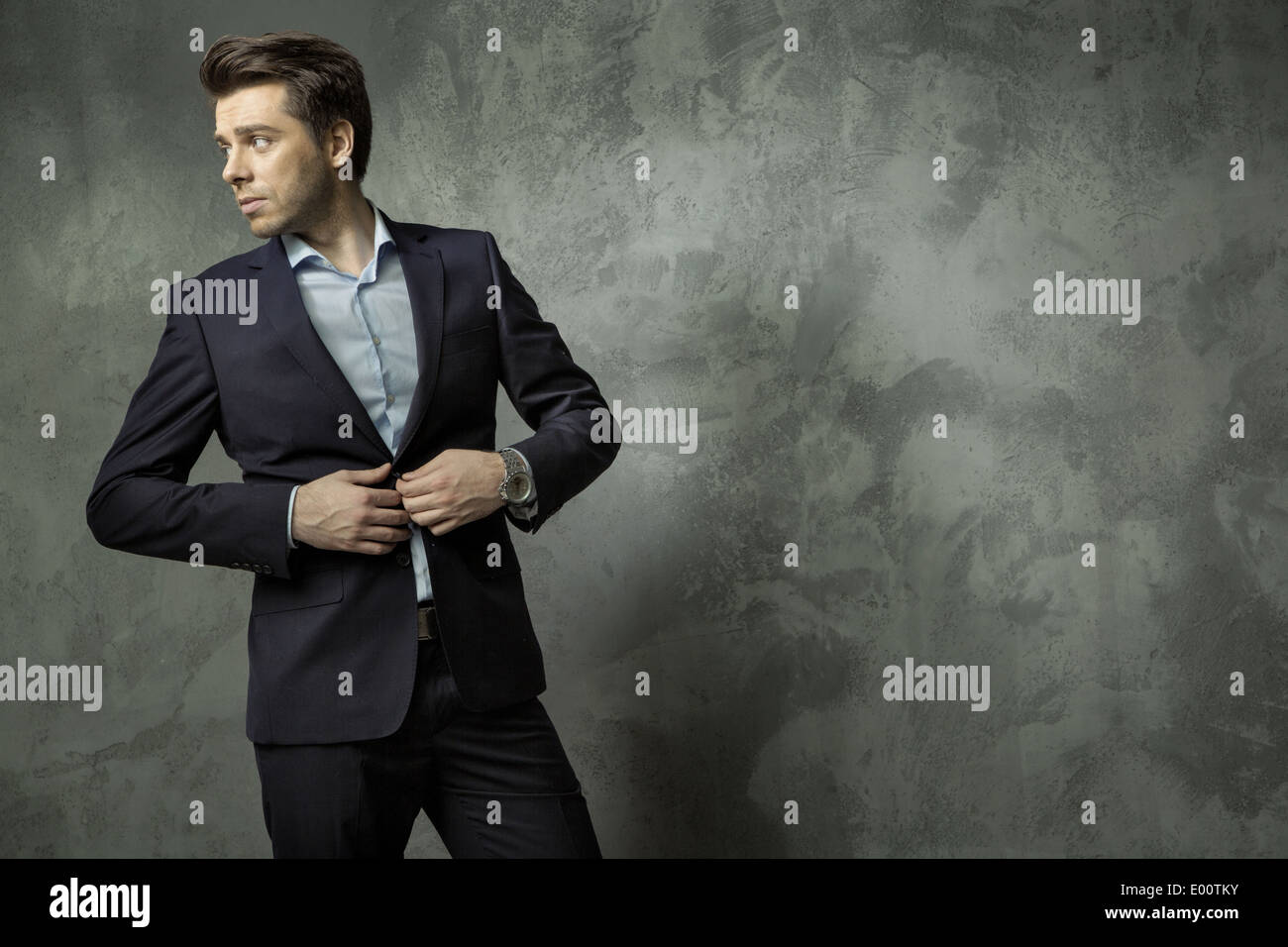 Successful young manager wearing black suit Stock Photo - Alamy