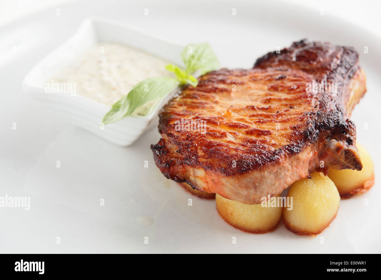 hot and tasty roasted meat on white dish Stock Photo - Alamy