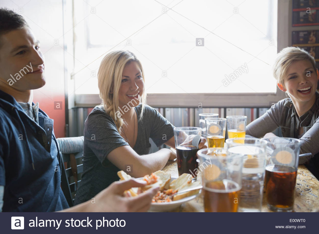 Three men eating together restaurant hi-res stock photography and ...