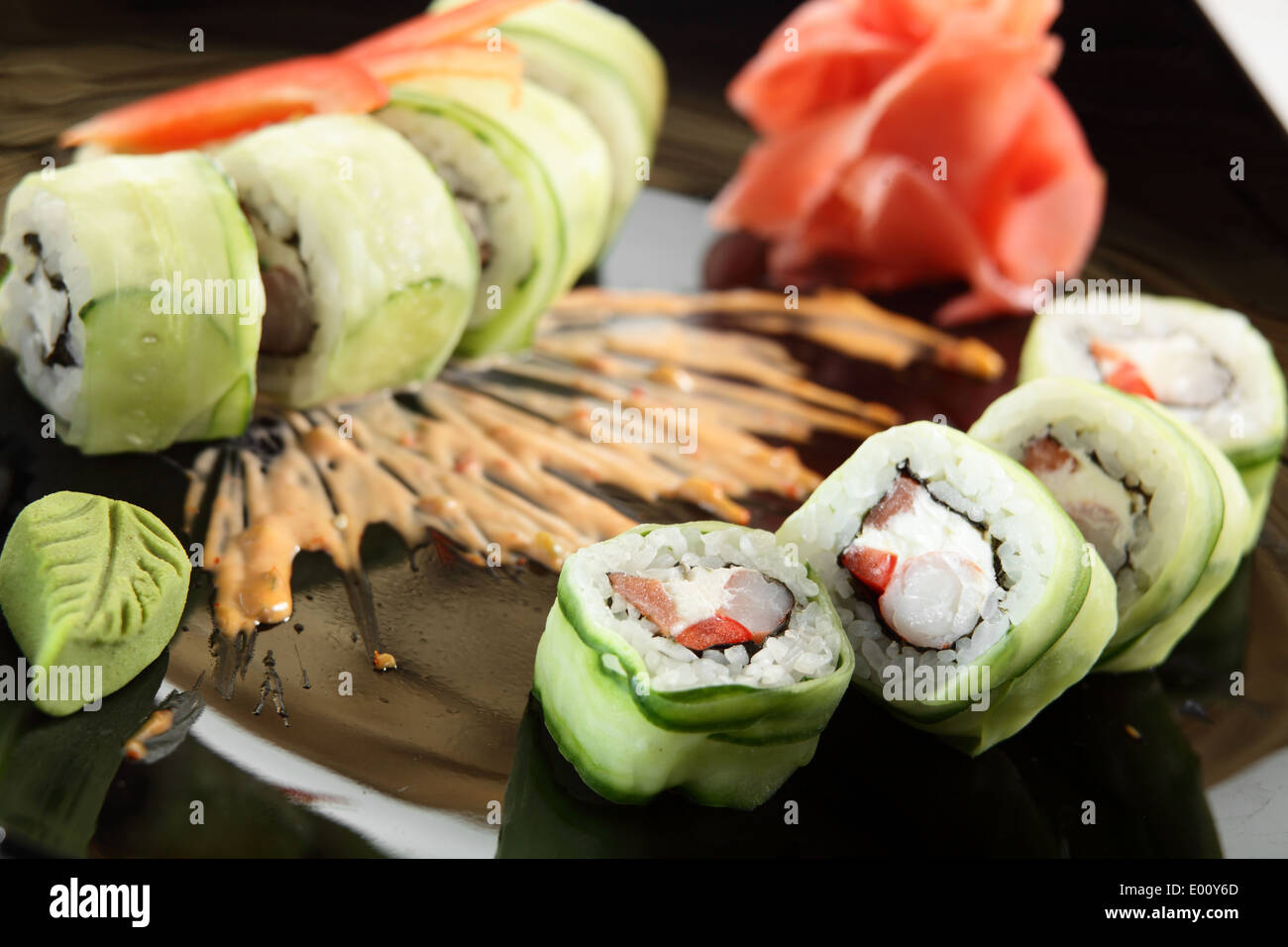 cold sushi on black dish and white background Stock Photo - Alamy