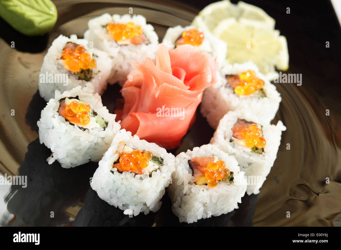 cold sushi on black dish and white background Stock Photo - Alamy