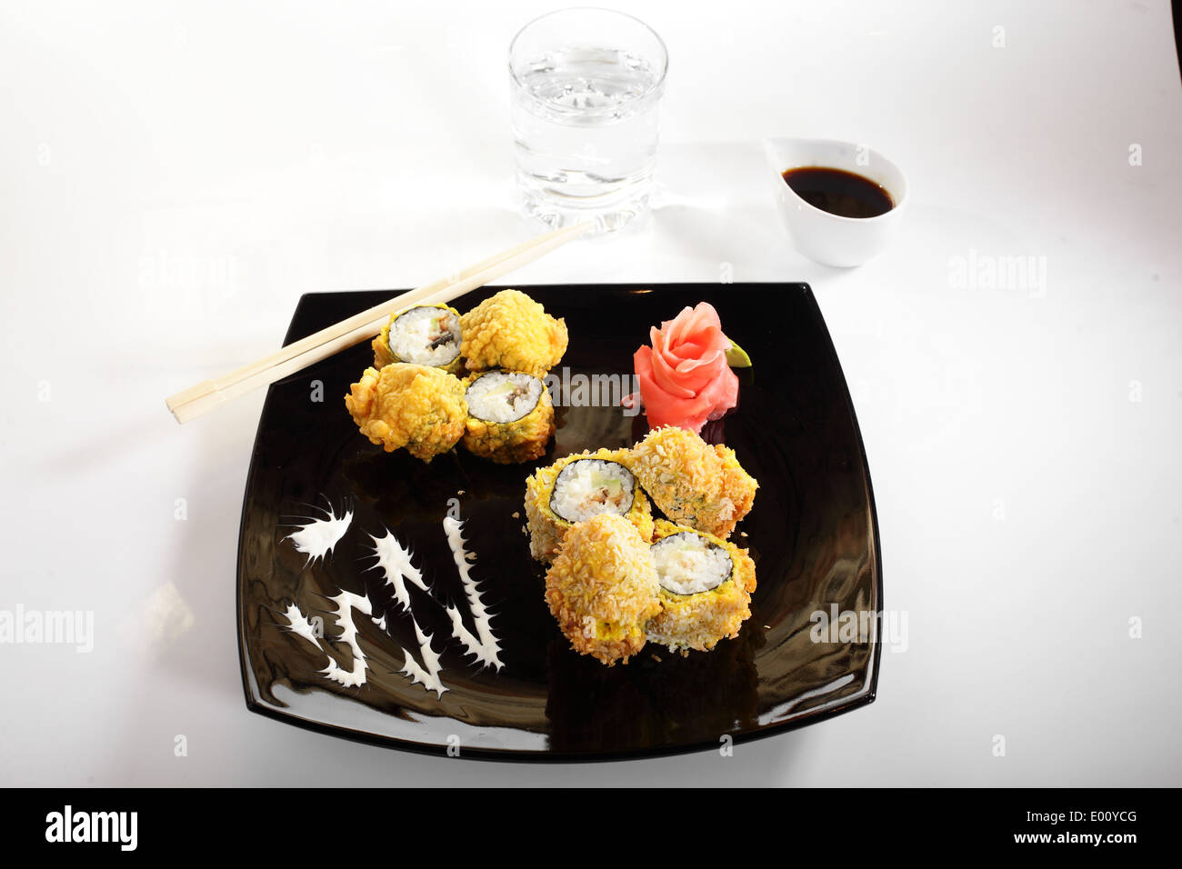 cold sushi on black dish and white background Stock Photo - Alamy